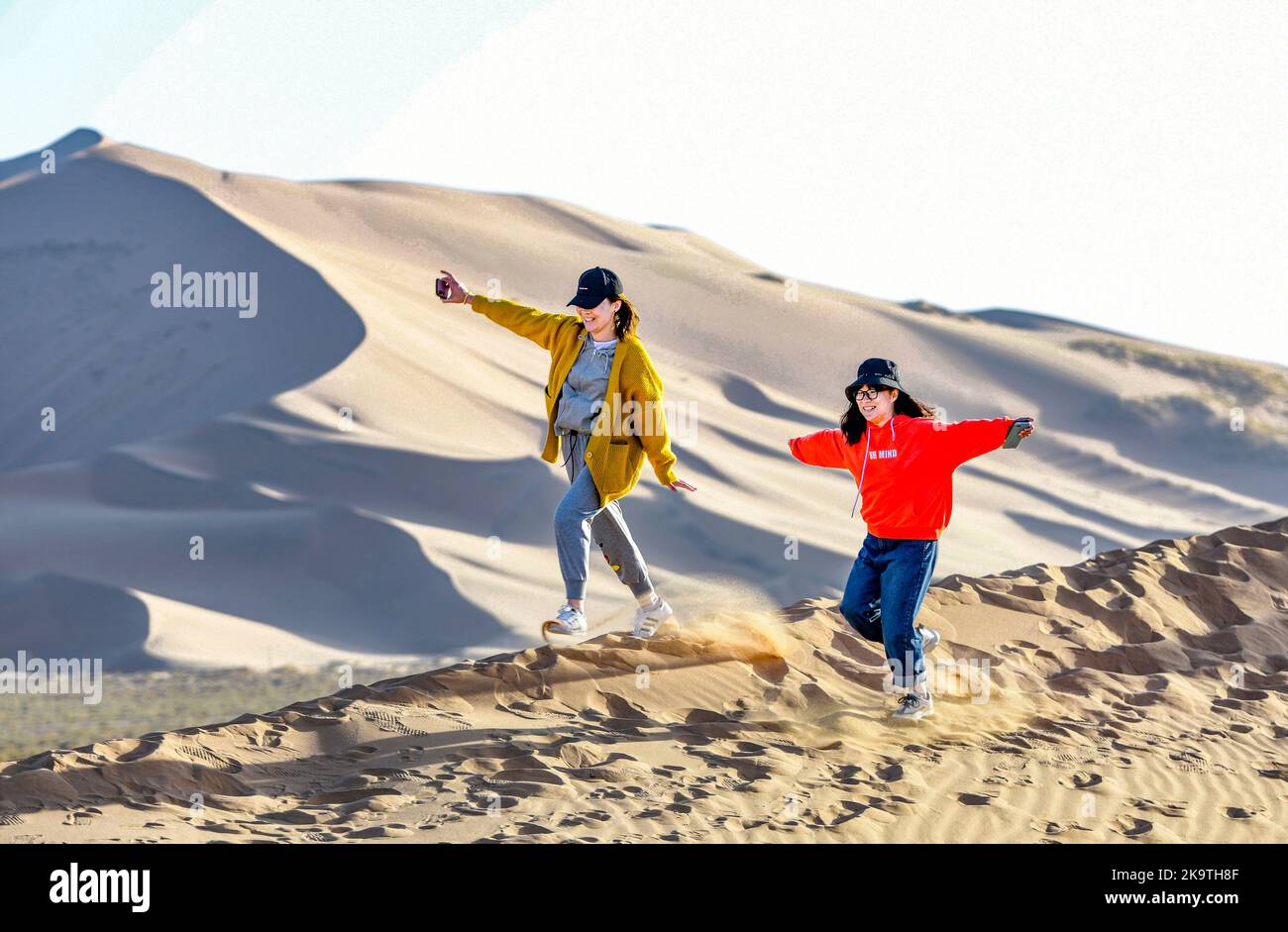 ALXA, CHINA - MAY 1, 2020 - Tourists play in the Badain Jaran Desert in ...