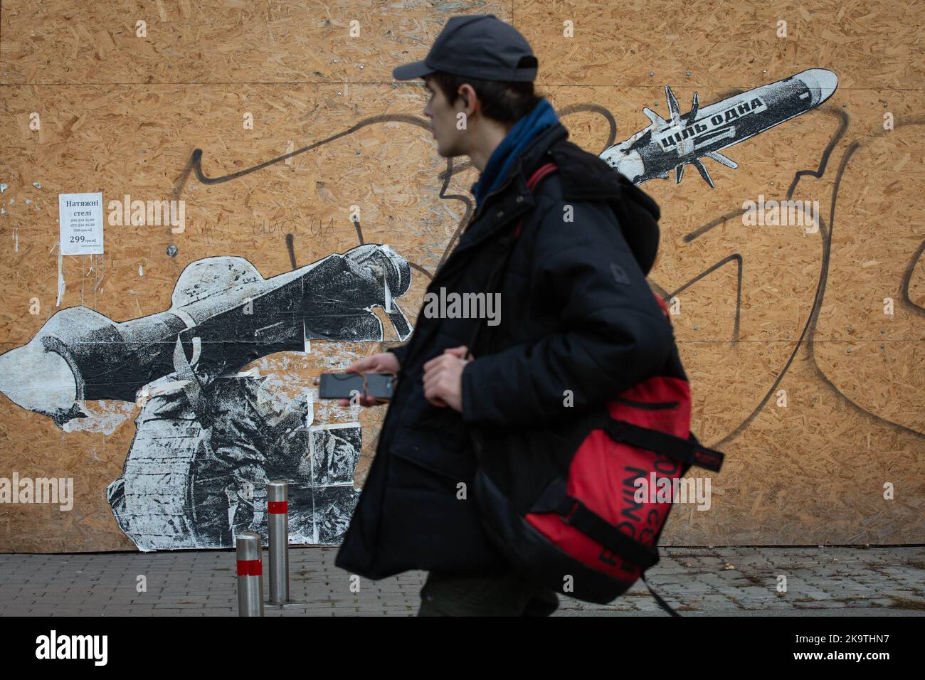 Kyiv, Ukraine. 29th Oct, 2022. A man passes by a graffiti depicting a ...