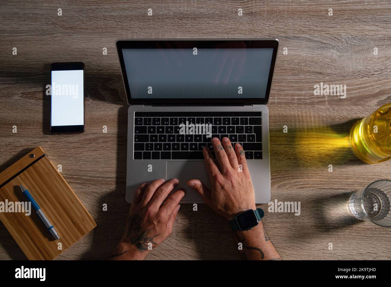 Overhead view of businessman using laptop computer and smart phone at ...
