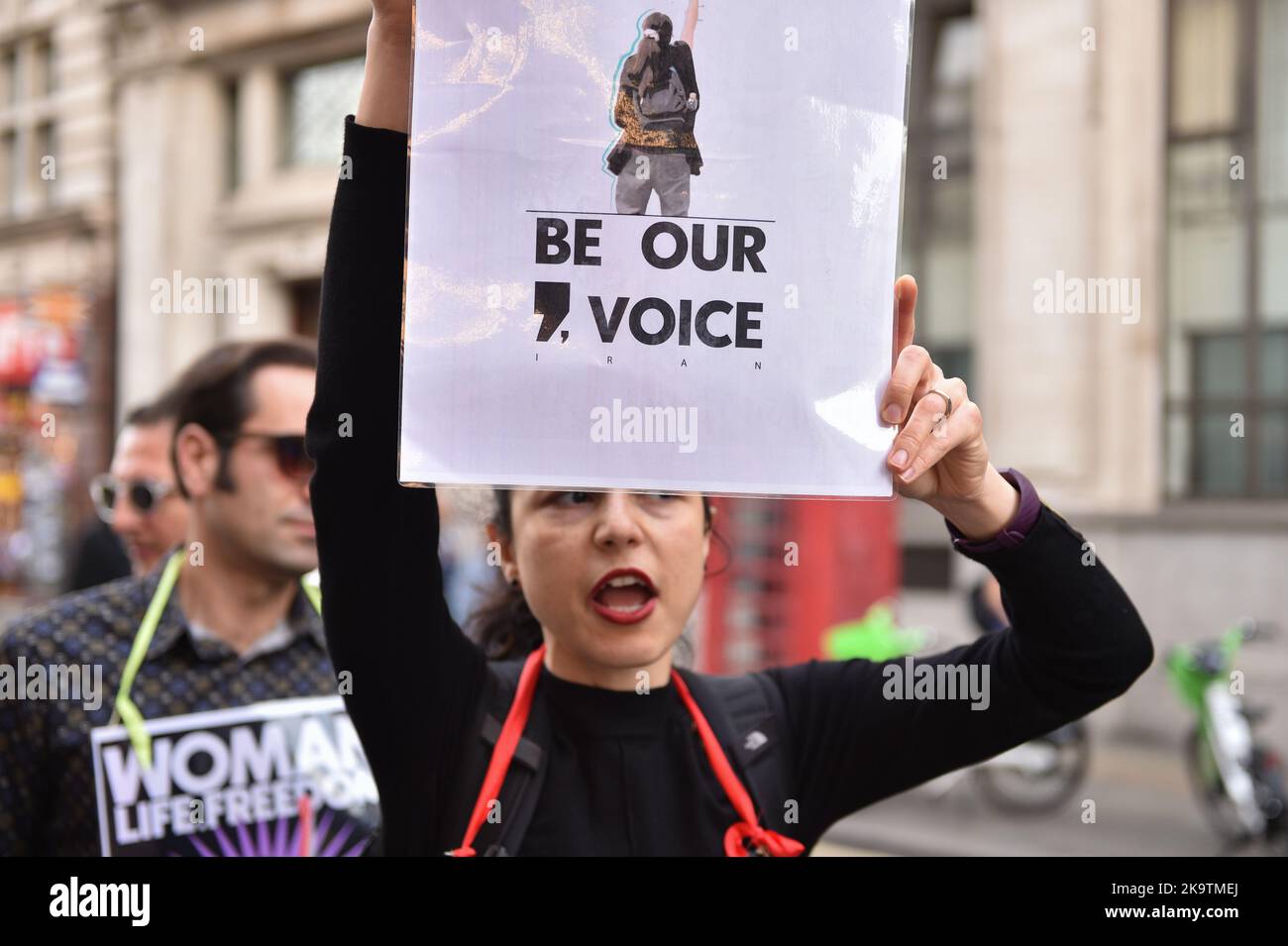 London, UK. 29th Oct, 2022. A protester chants slogans while holding a ...