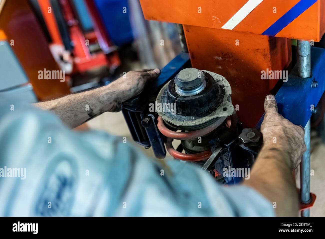 Mechanic hands detail during a maintenance of car suspension Stock ...