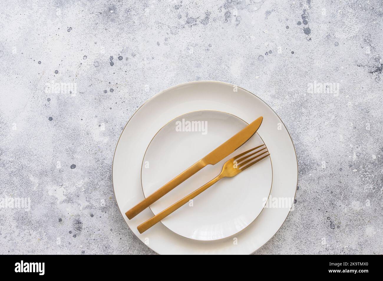 Gold cutlery knife and fork on plate for restaurant dinner concept.Copy ...