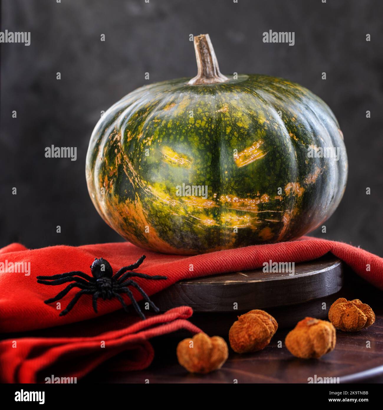 Fresh pumpkin with natural scary face on concrete background for ...