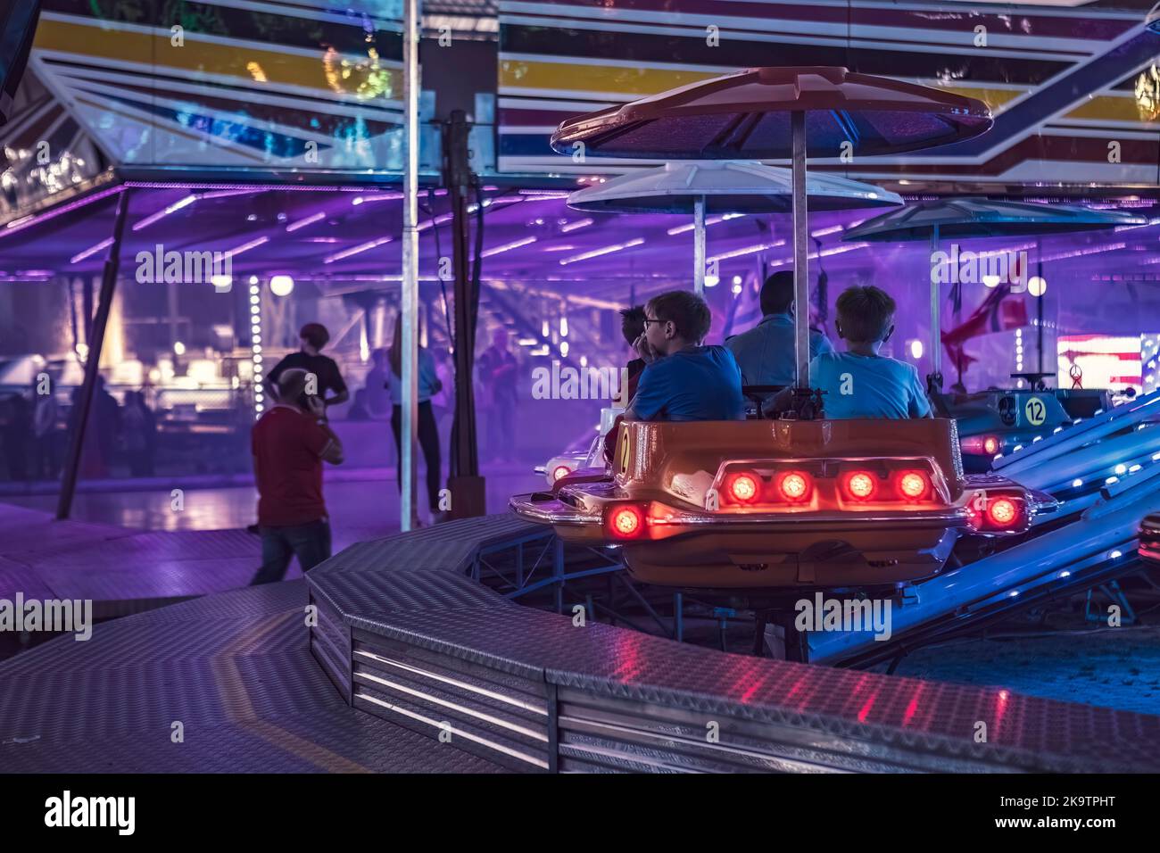 Rovigo, Italy 25 October 2022: Carousel fairground plane with children ...