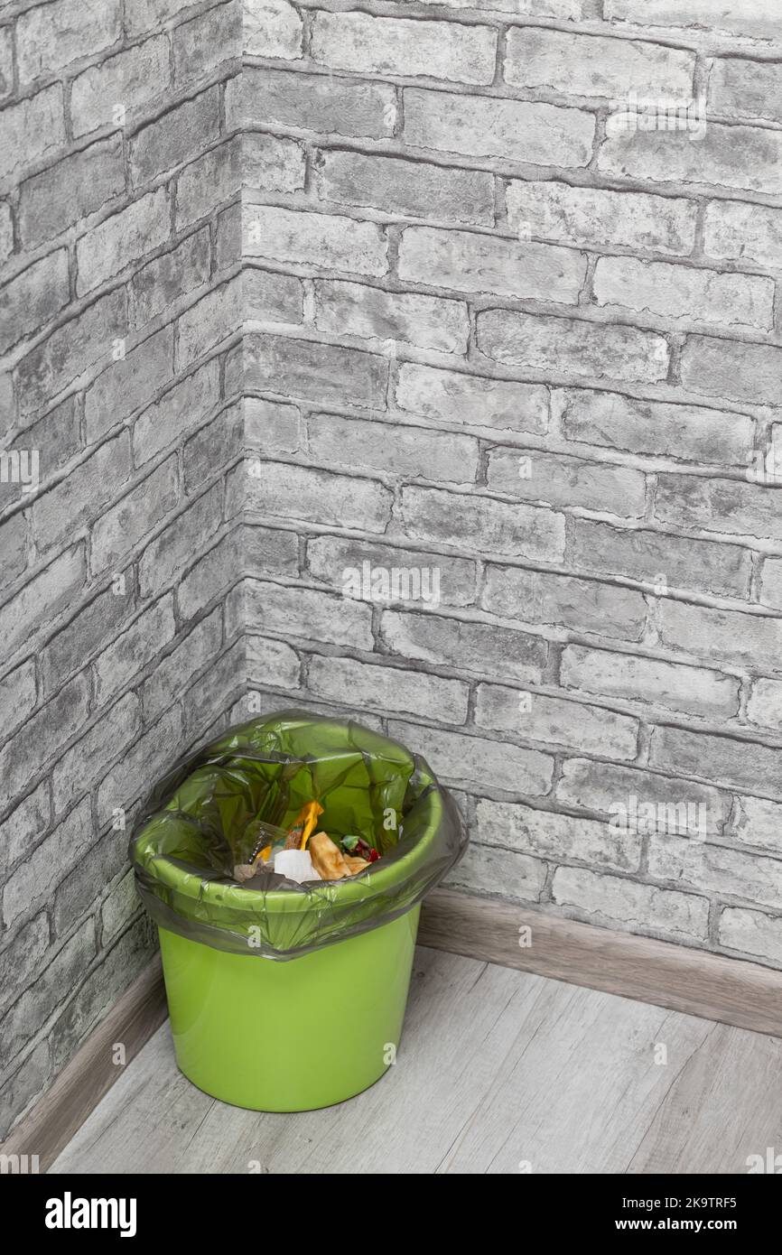 a bucket of garbage is in the corner. bucket with trash bag Stock Photo ...