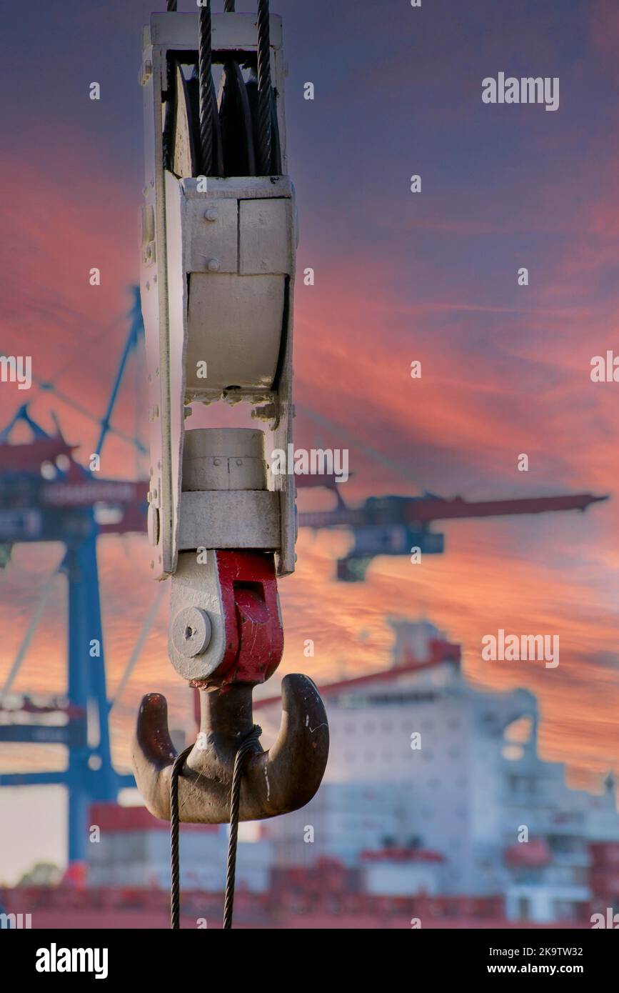 Old harbour crane for general cargo, behind it container ship, harbour ...