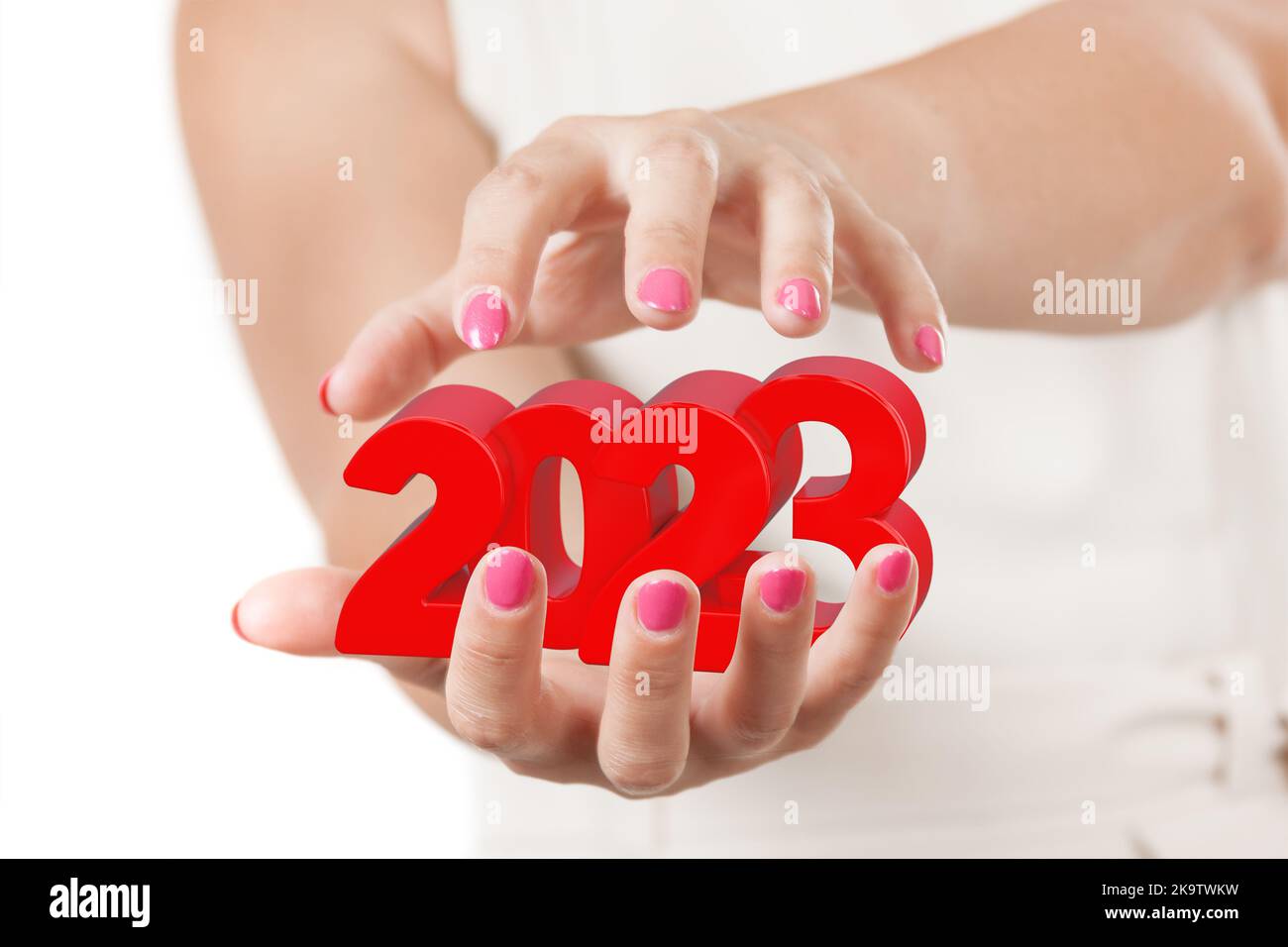 Two Woman Hands Protecting 2023 New Year Sign on a white background Stock Photo - Alamy