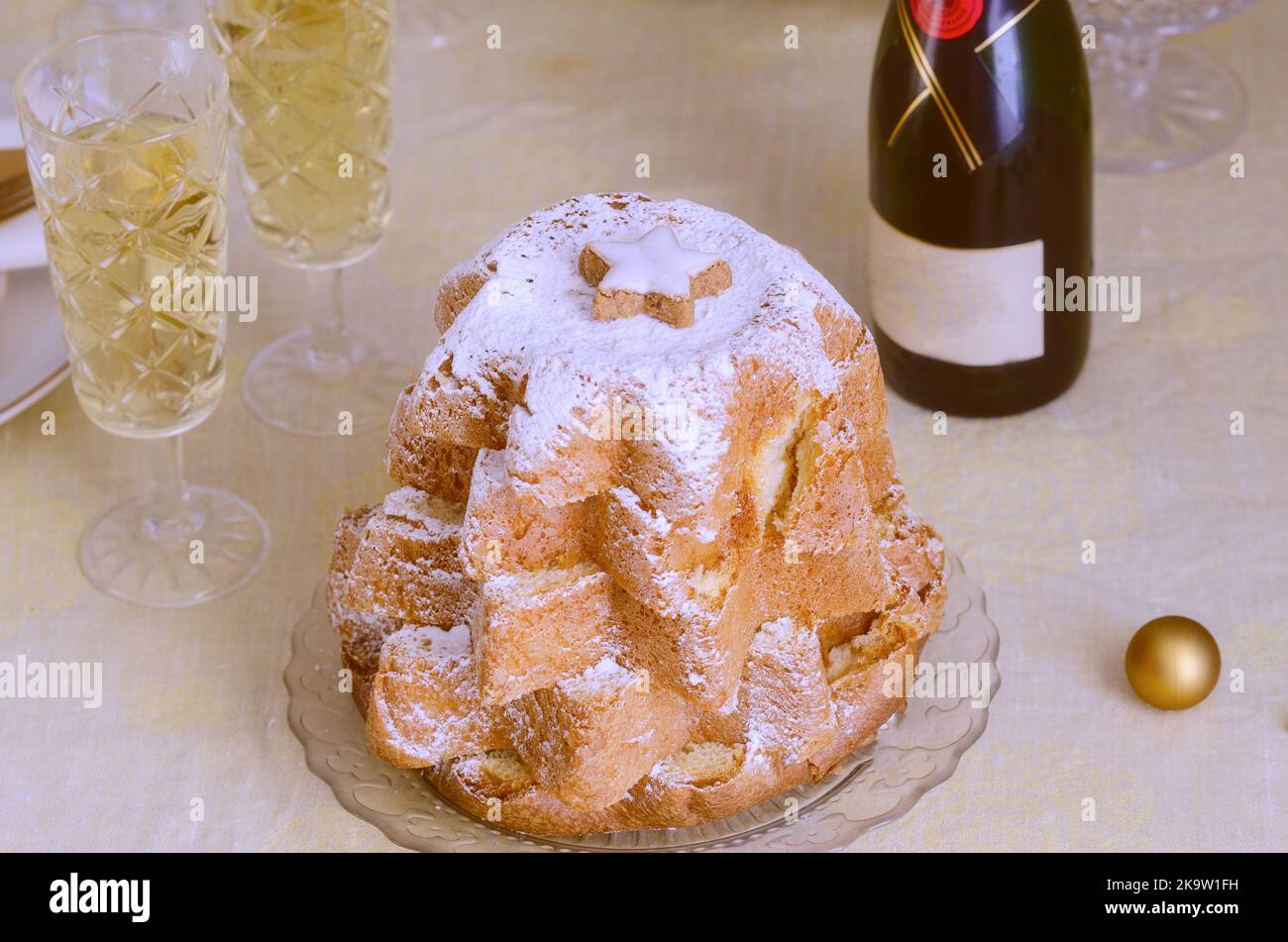 Italian Christmas cake Pandoro on the table with gold Christmas ...
