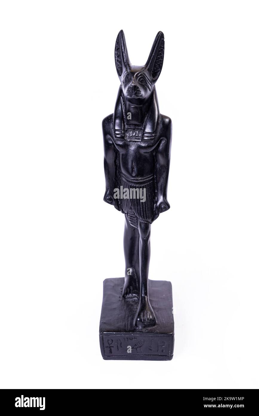 stone figurine of egyptian god Anubis with jackal head isolated on white background. side view ...