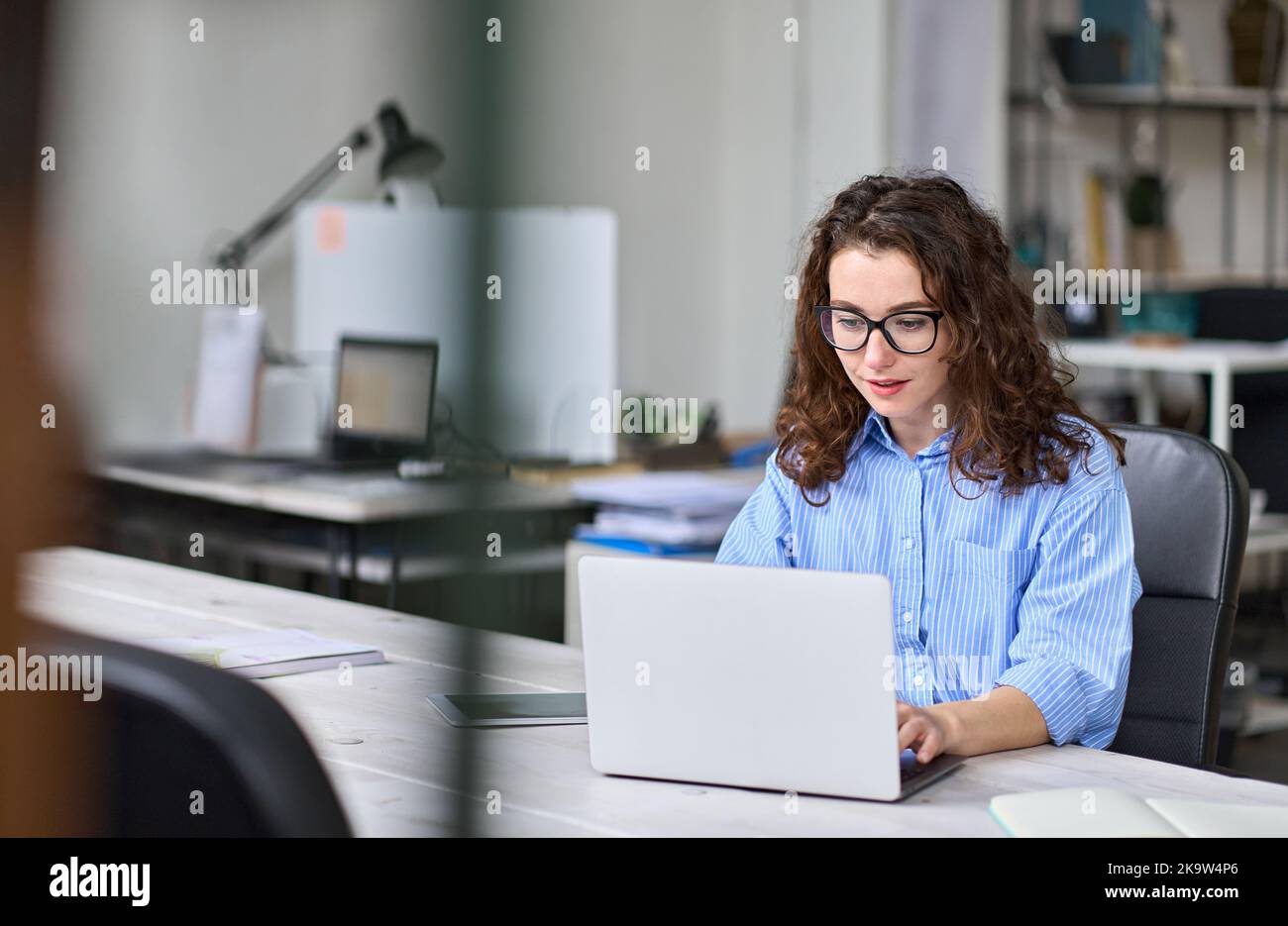 Young business woman worker working using laptop in modern office sit ...
