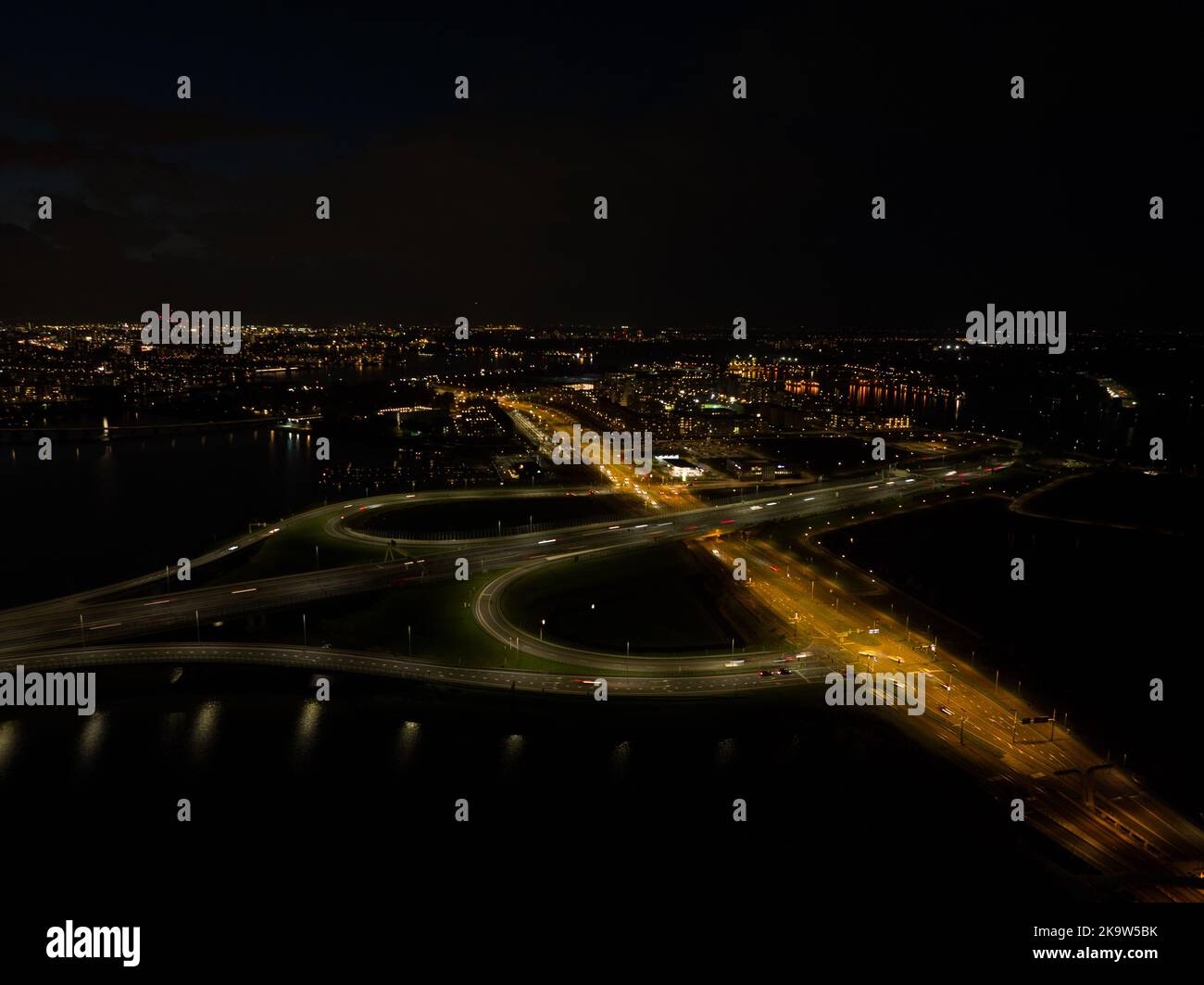 A10 Highway traffic at night. Motorway infrastructure in darkness light ...