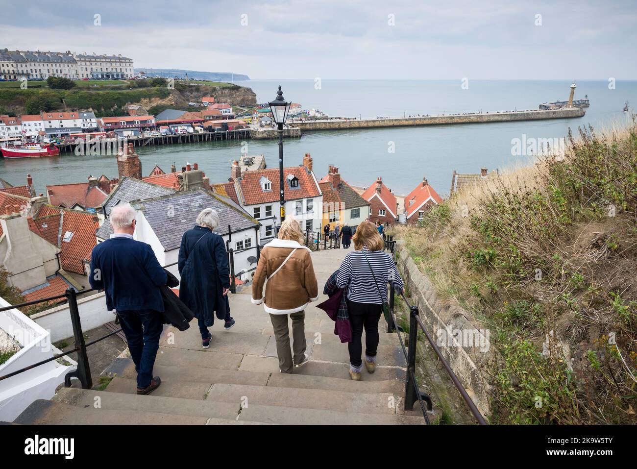 WHITBY, UK - September 21, 2022. Tourists walk down Whitby Abbey steps ...