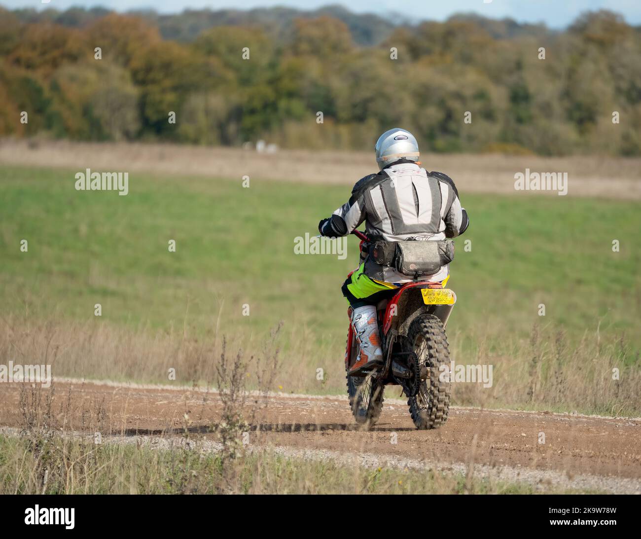 a motor cyclist (biker) riding their off-road motorbike along a stone ...