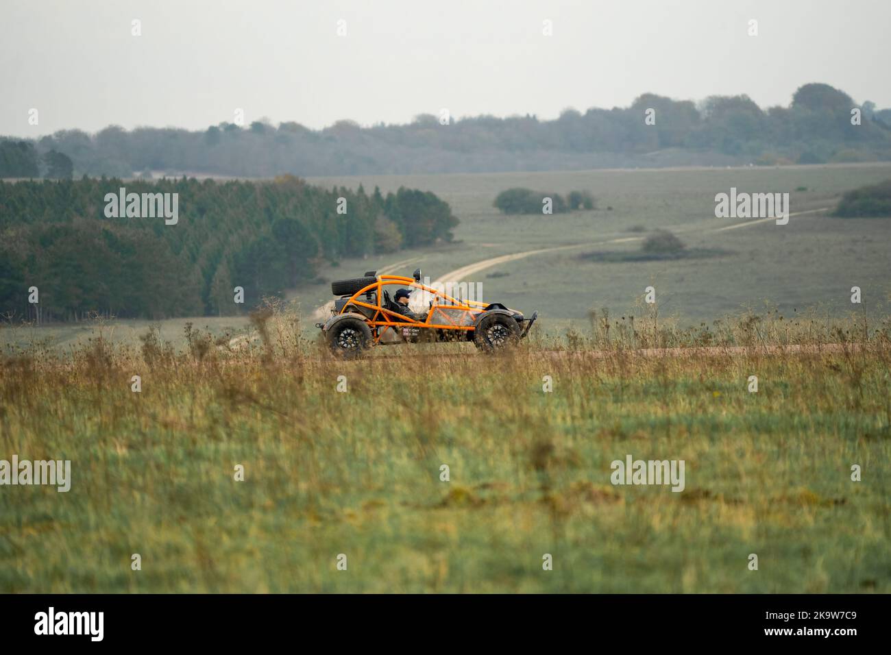 a space frame cross country buggy driving a track in open countryside ...