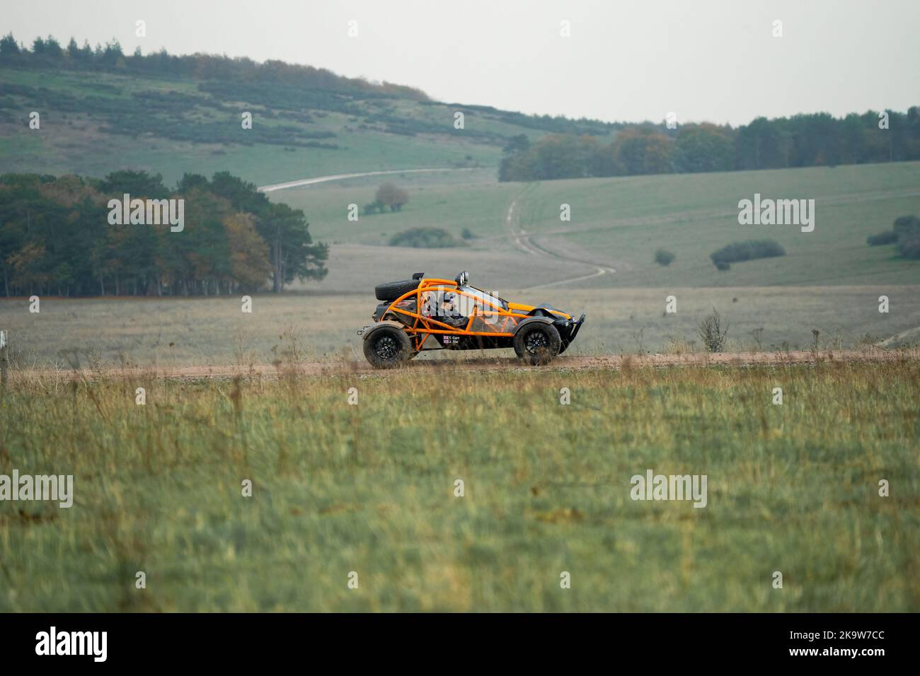 a space frame cross country buggy driving a track in open countryside ...
