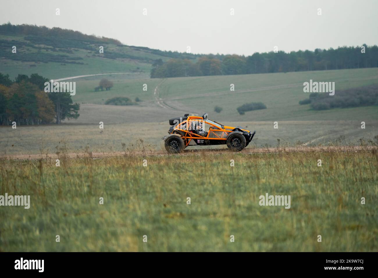 a space frame cross country buggy driving a track in open countryside ...