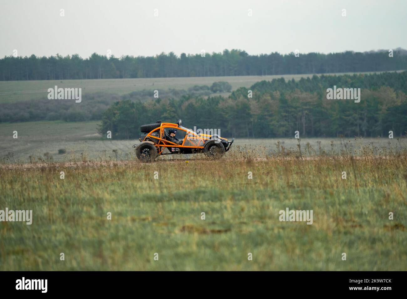 a space frame cross country buggy driving a track in open countryside ...
