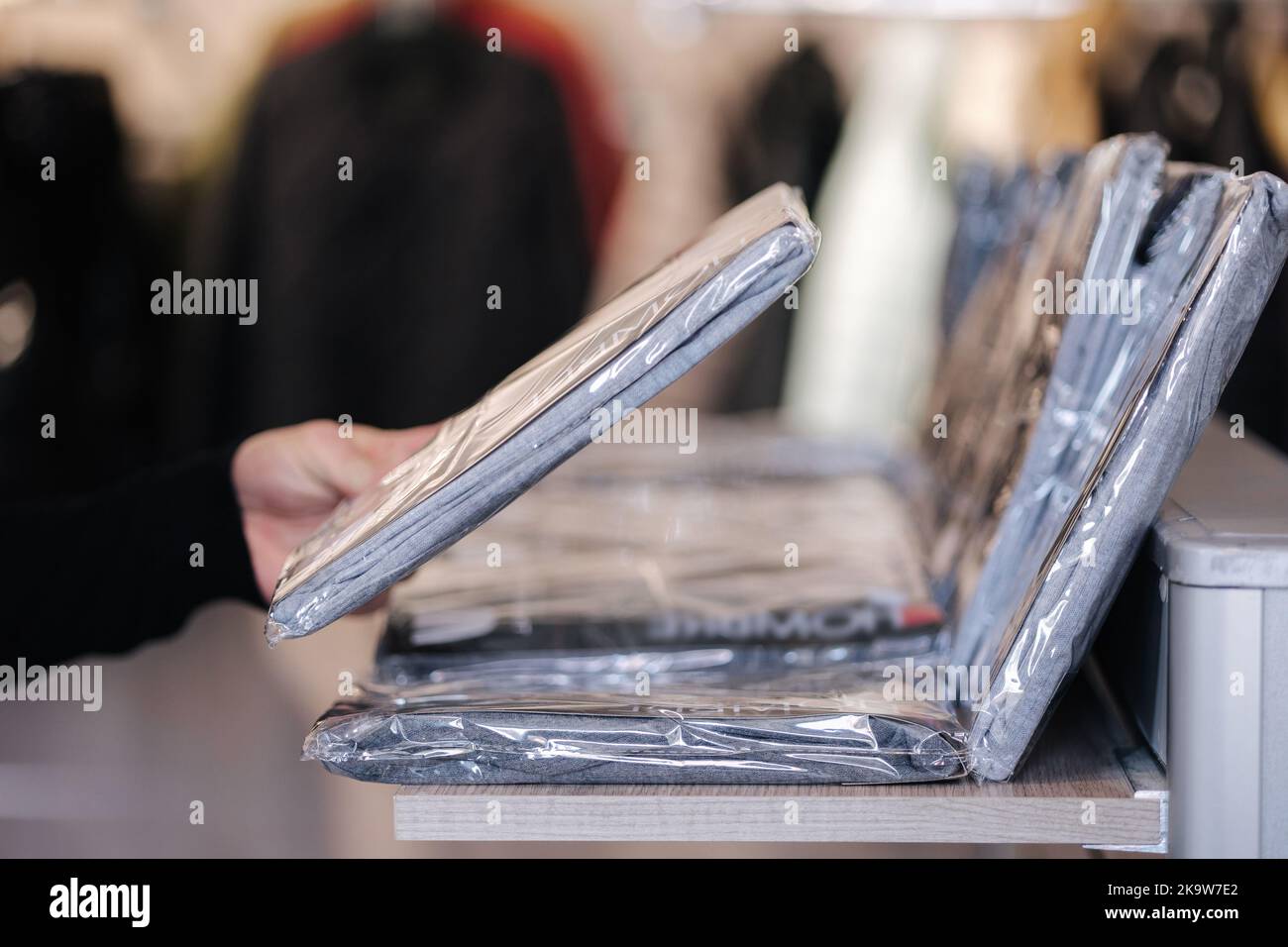 Close-up of human hand take goods from the shelf in clothes store Stock ...