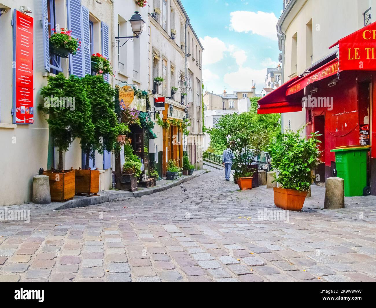 Paris France - June 22 2009; Cobbled lane between restaurants and blue ...