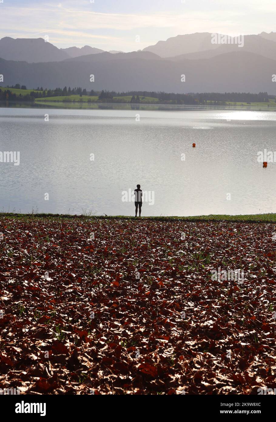 Rieden, Germany. 30th Oct, 2022. A man is standing in the sunshine on ...