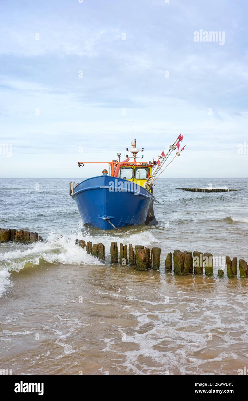 Fishing boat stranded on a beach Stock Photo - Alamy