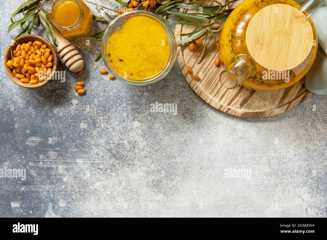 Sea buckthorn and cup of healthy sea buckthorn tea with honey on a ...