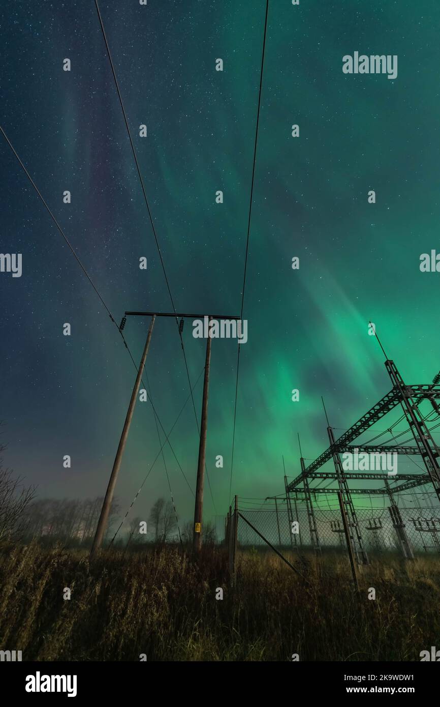 Beautiful night Aurora over double wooden pole power lines and ...
