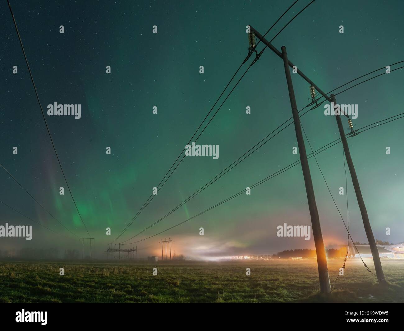 Beautiful night Aurora over double wooden pole power lines and ...