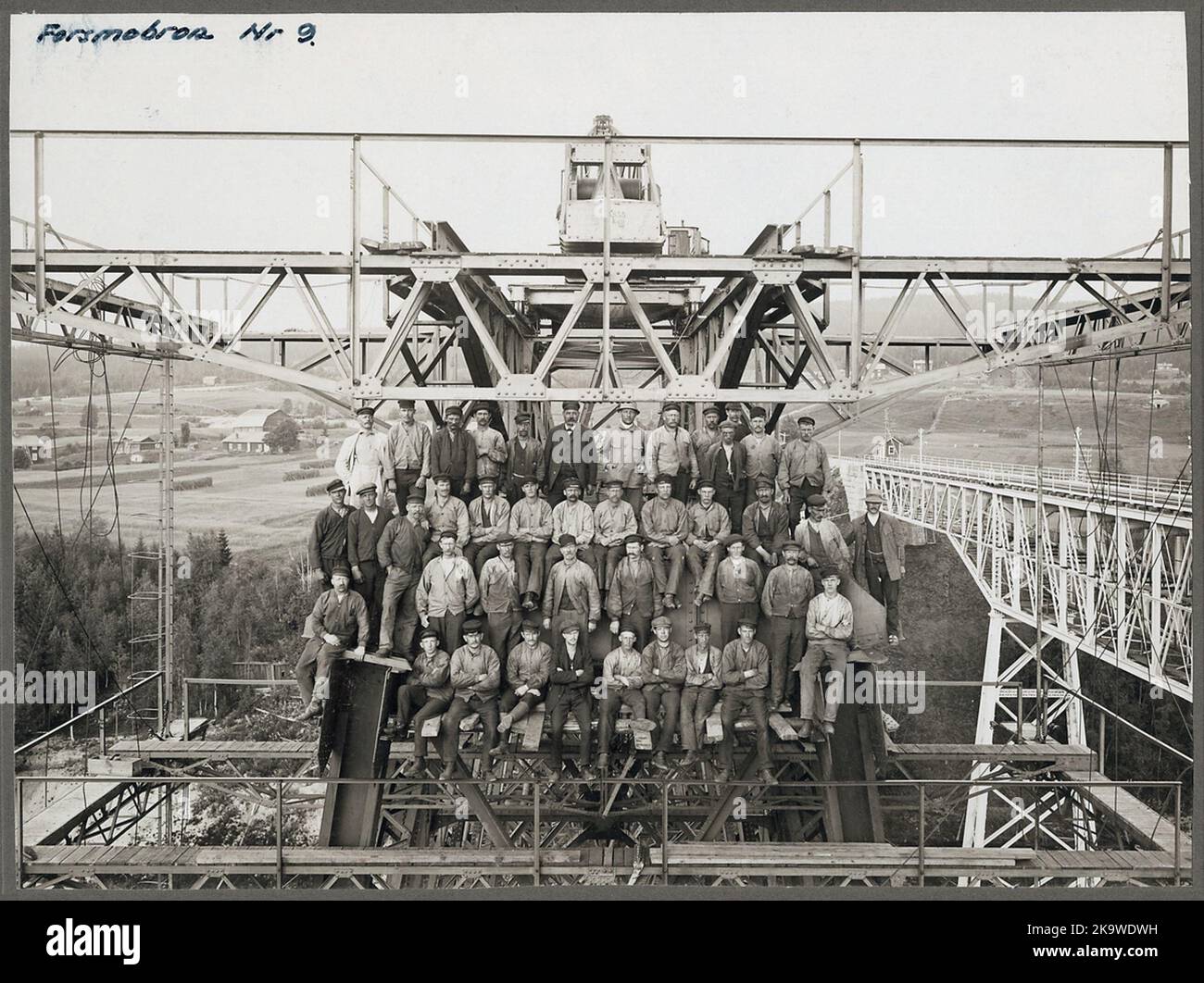Construction workers and staff in front of the railway bridge over the ...