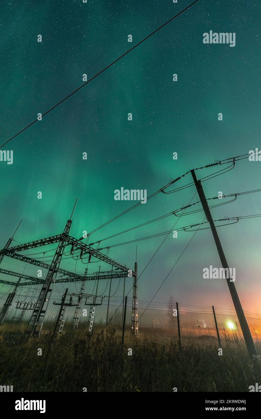 Beautiful night Aurora over single wooden pole power lines and ...