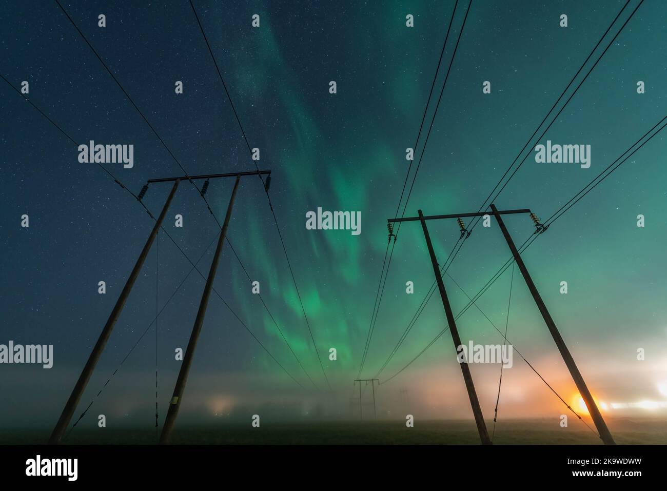 Beautiful night Aurora over two double wooden pole power lines in ...