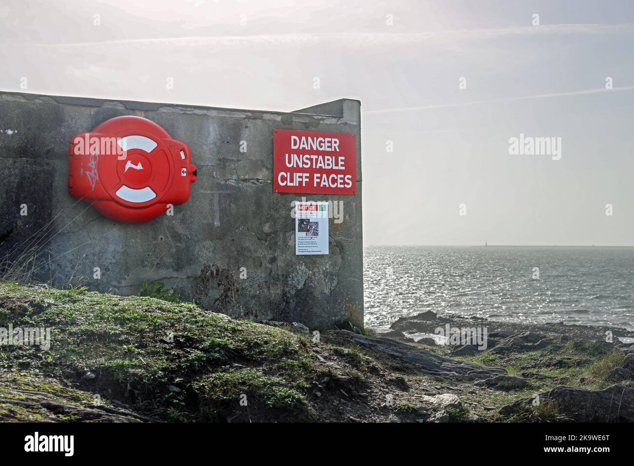 Warning signs of unstable cliffs and asbestos fragments on the beach at ...