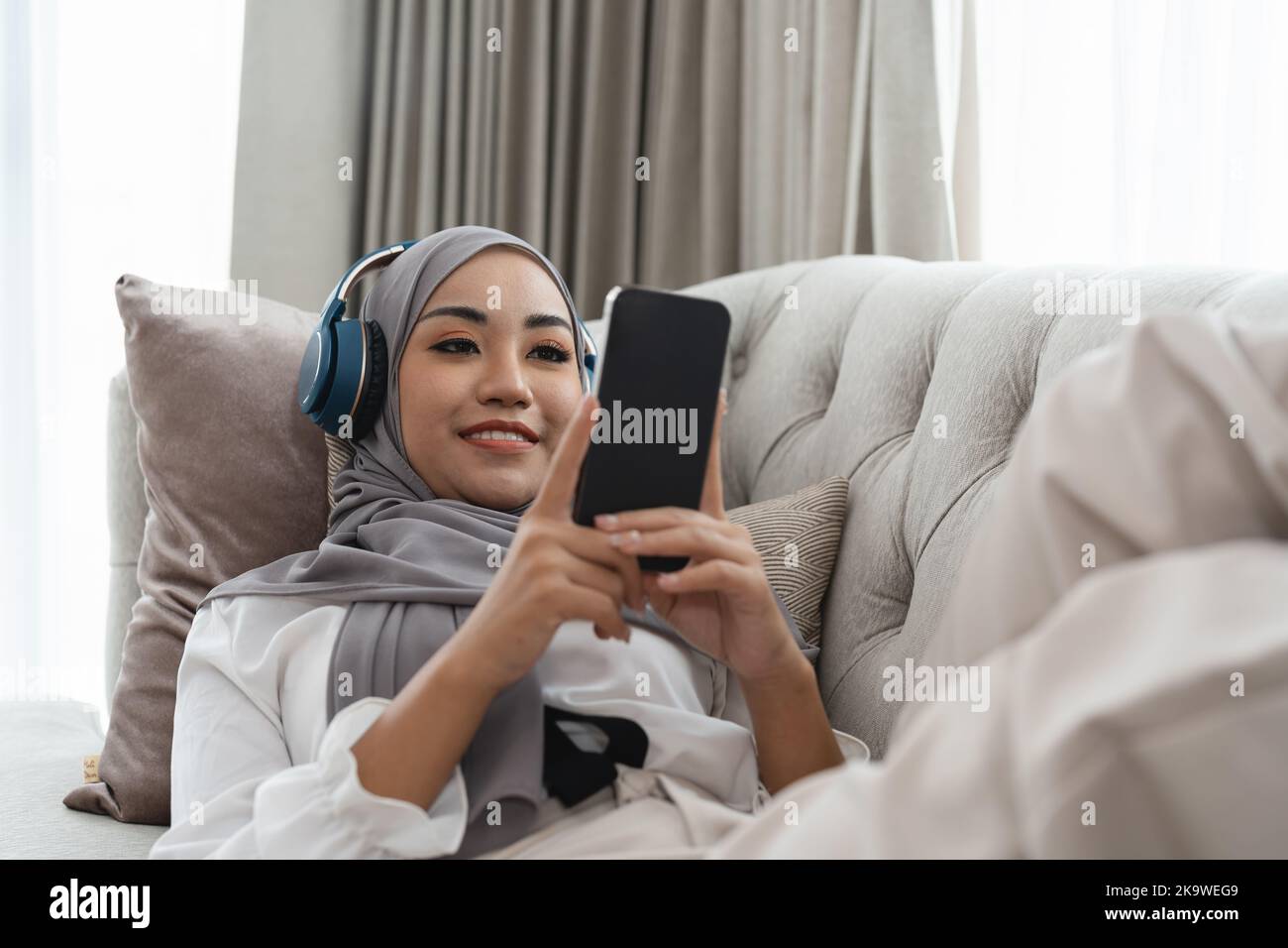 Music For Relax. Calm asian Girl In Hijab And Wireless Headphones ...