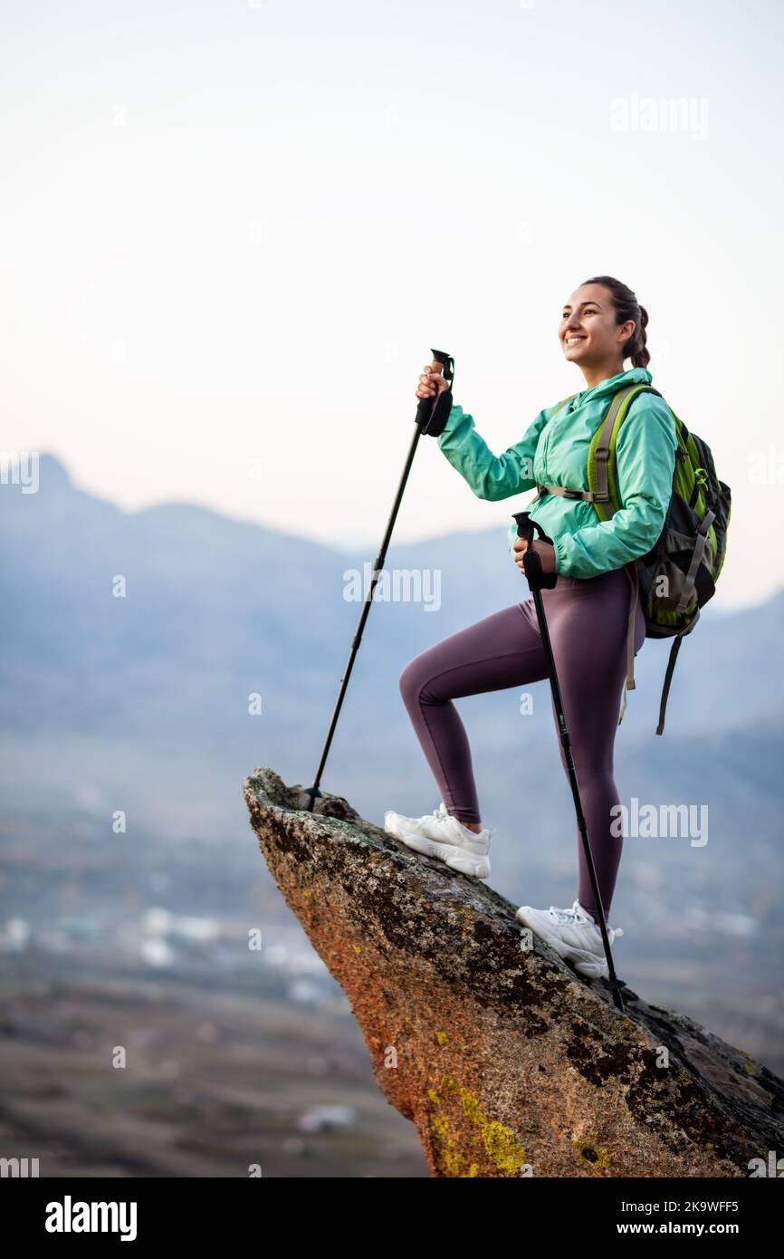 Hiker Girl Resting On A Rock Pedestal After Long Day Trekking Woman Enjoying The Sunset In