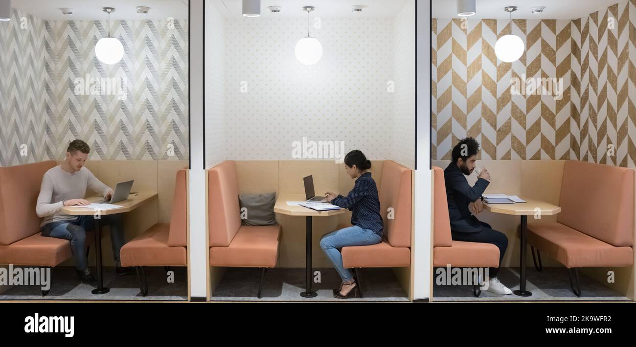 Workflow in modern coworking space of three diverse businesspeople ...