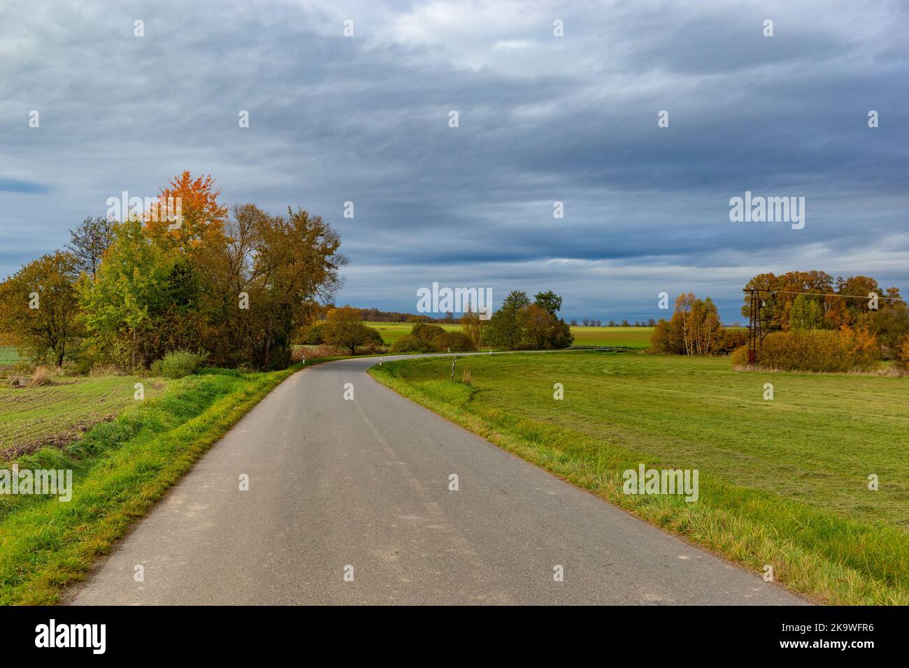 Rural road between fields and forests. Late fall. Europe Stock Photo ...