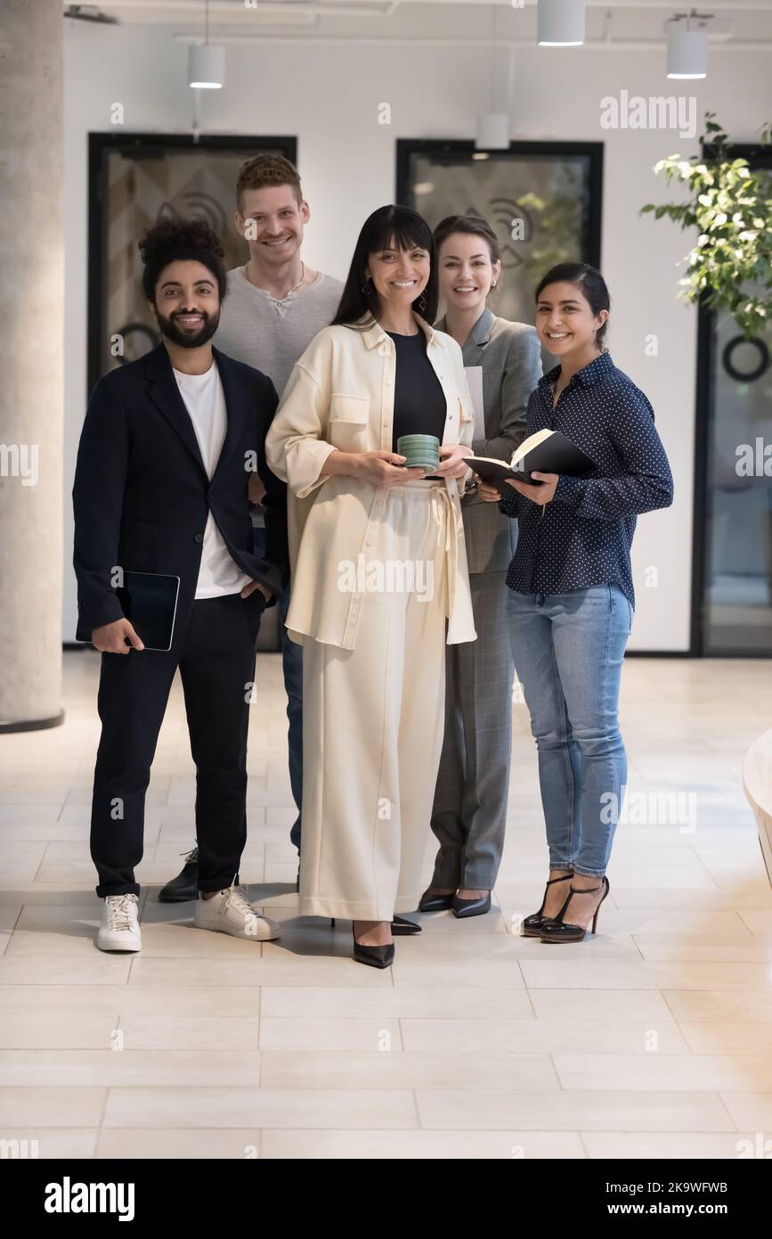 Corporate staff pose in modern workspace smile look at camera Stock ...