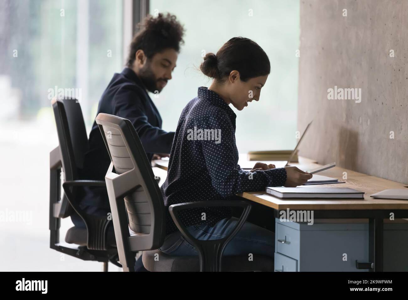 Two Indian office employees working seated at table Stock Photo - Alamy