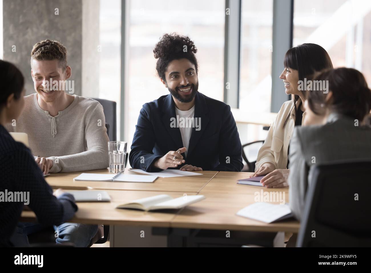 Smiling Indian businessman talking to clients at formal meeting Stock ...