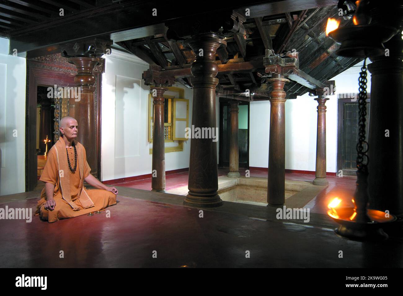 India: Older woman meditating in the Ashram of the Ayurvedic Place in ...