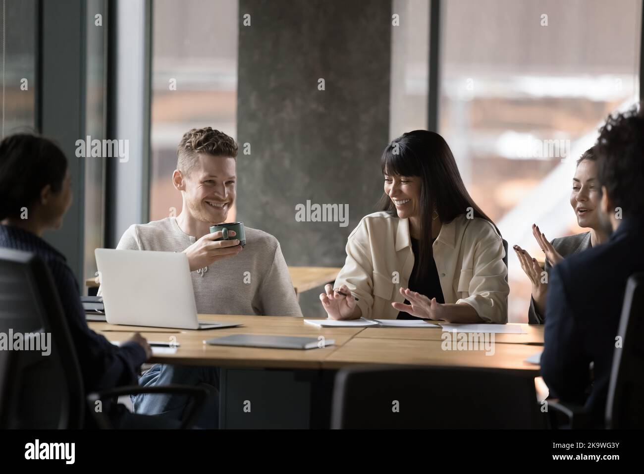 Group of smiling colleagues gathered in modern boardroom Stock Photo ...