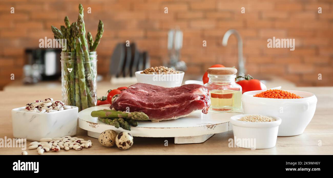 Different healthy food on table in kitchen Stock Photo - Alamy