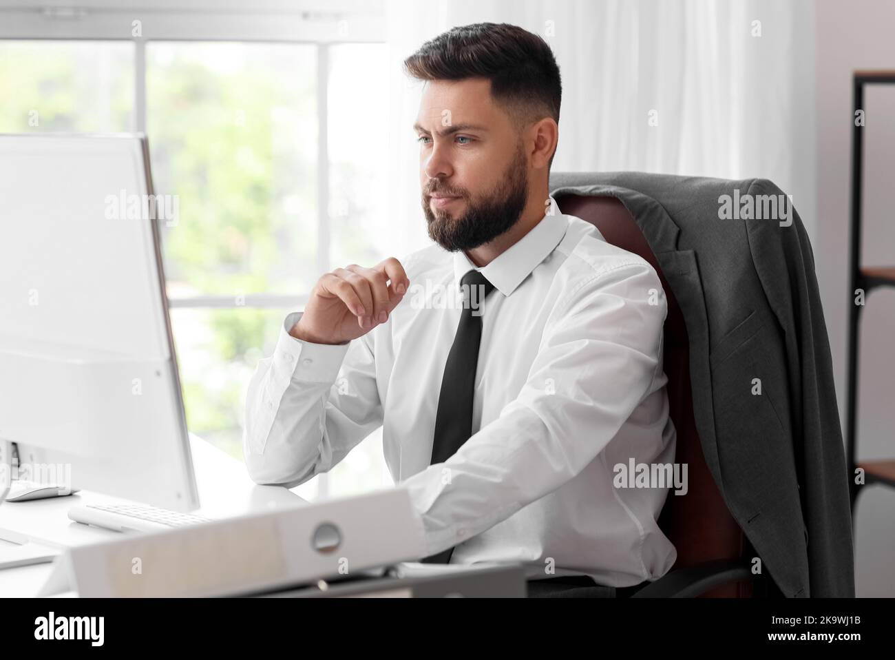 Handsome bank manager working with computer at table in office Stock ...