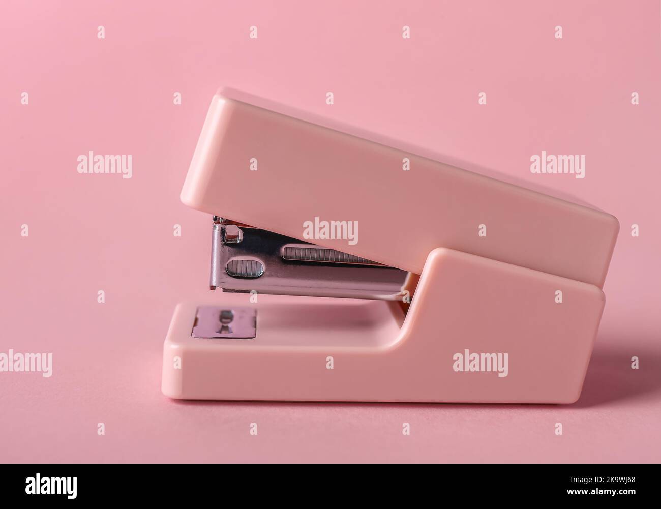 Office stapler on pink background Stock Photo - Alamy