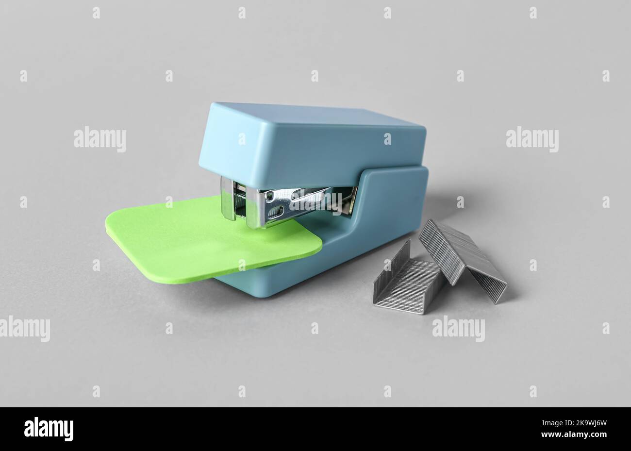 Office stapler with sticky notes and staples on grey background Stock ...