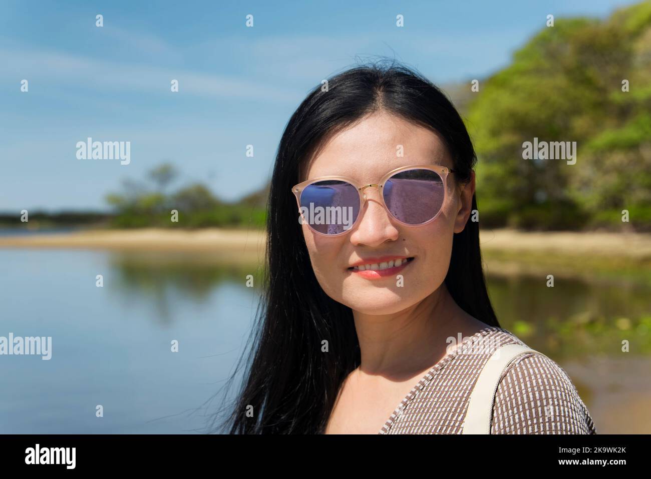 A happy chinese woman posing with a nature landscape background in New ...