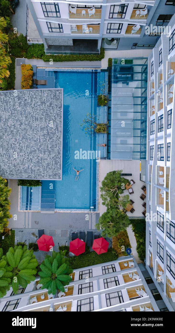 Drone view from above at the swimming pool. Couple men and women in ...