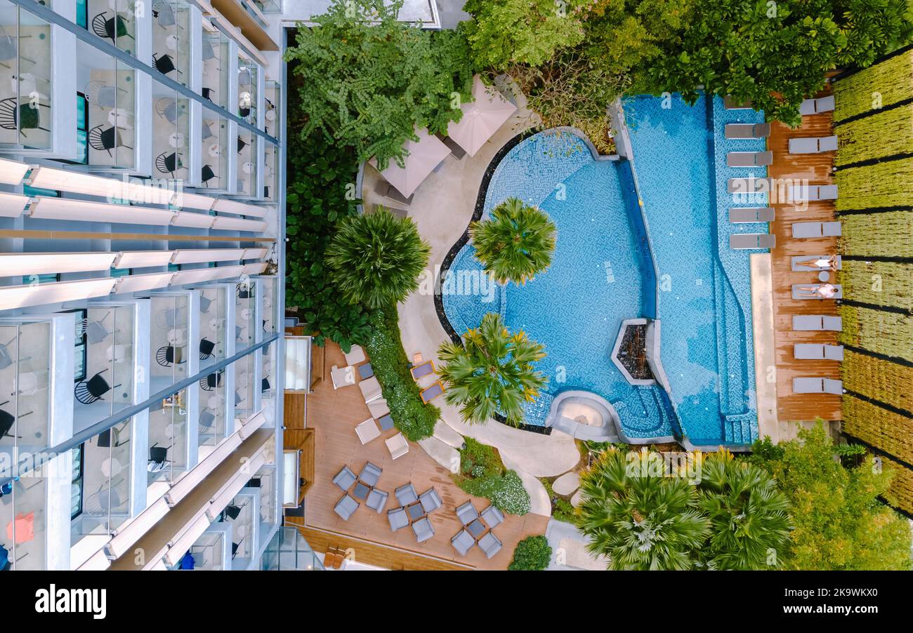 Drone view from above at the swimming pool. Couple men and women in ...