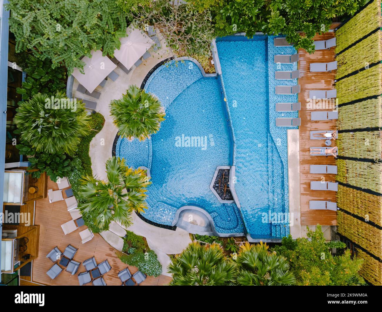 Drone view from above at the swimming pool. Couple men and women in ...