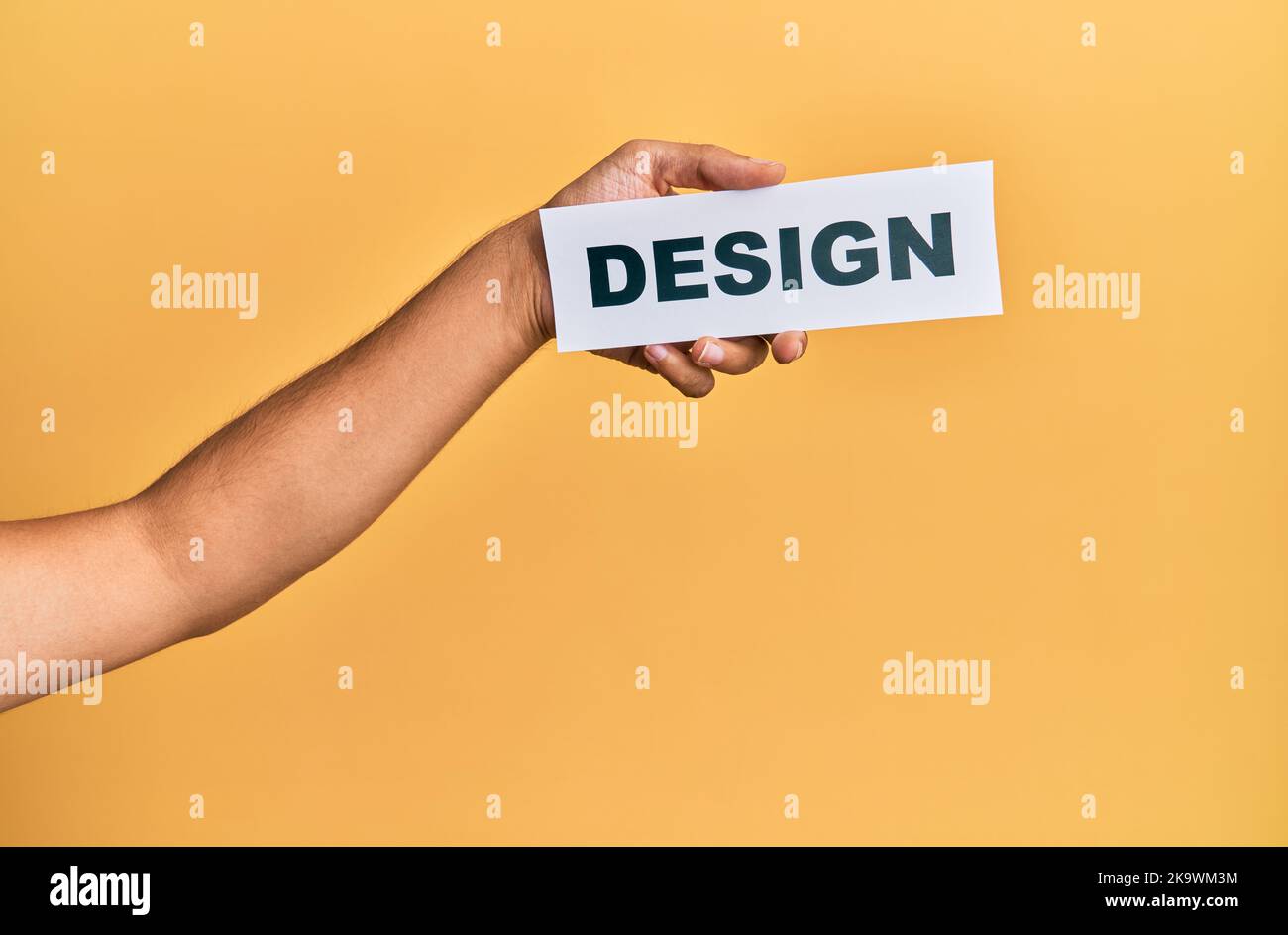 Hand of caucasian man holding paper with design word over isolated ...